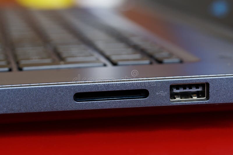 USB Port and Card Reader of a Modern Laptop on a Red Background ...