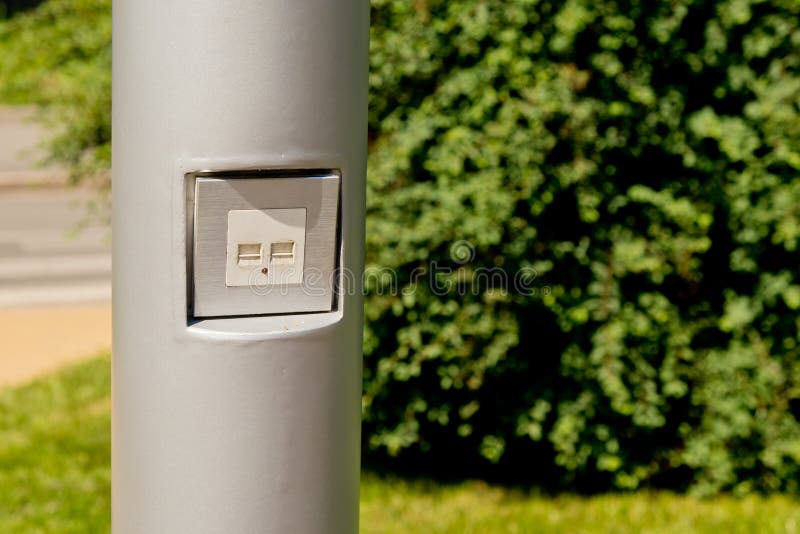 USB Socket for Charging Mobile Phones on a Pole in the Park. Stock ...