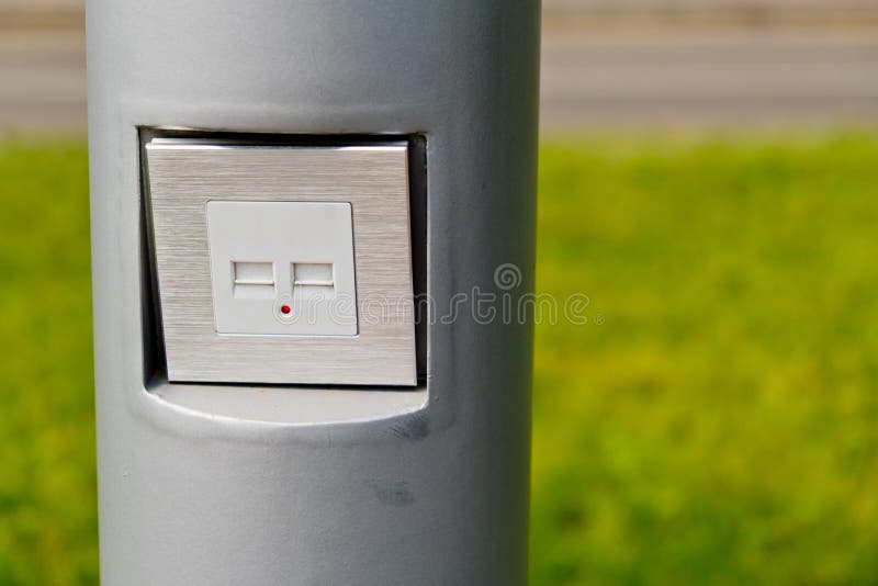 USB Socket for Charging Mobile Phones on a Pole in the Park. Stock ...