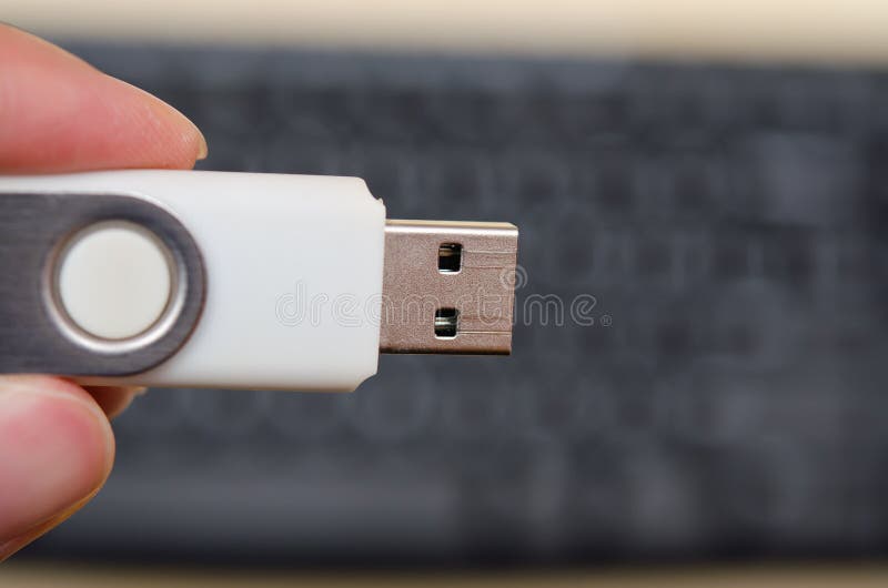 USB Thumb Drive with Hand Holding on Keyboard Background Stock Photo ...