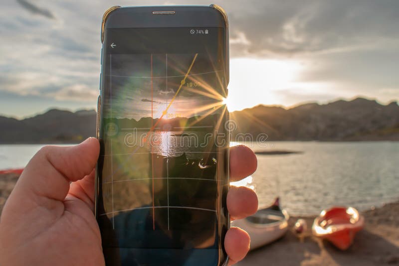 Use Cell Phone Take Pictures the Sunset on the Beach. in the Summer ...