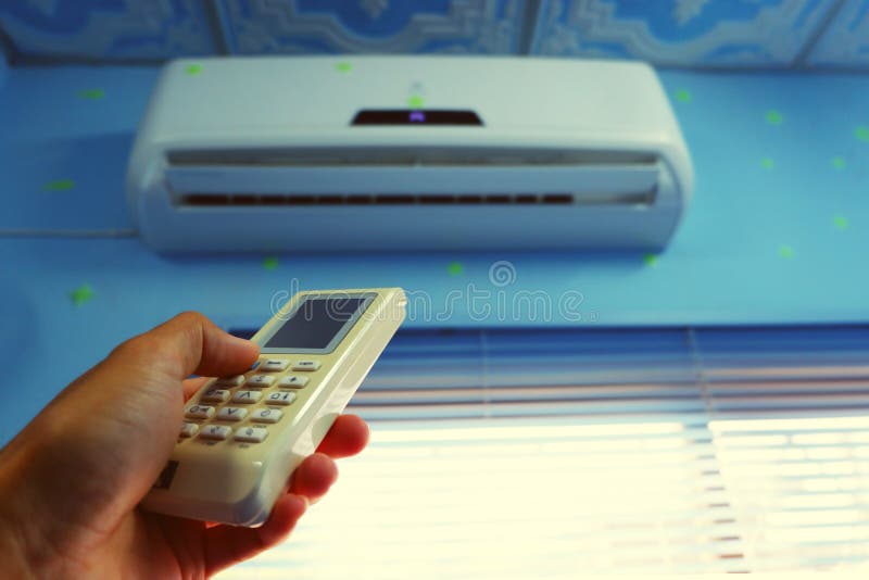 Use Hand is Press Remote Control for Open Air Conditioner in the ...