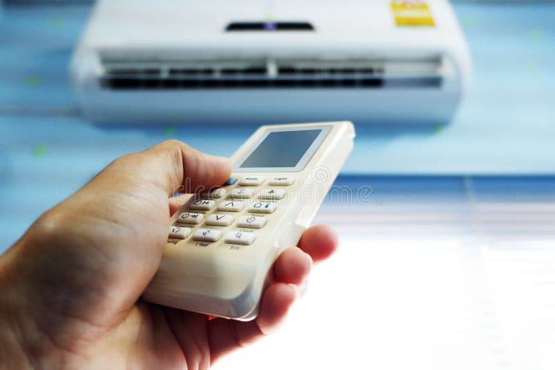 Use Hand is Press Remote Control for Open Air Conditioner in the ...