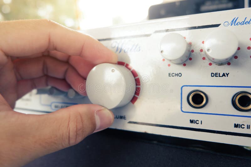 Use Hand To Adjust the Volume at the Volume Control Button of the ...