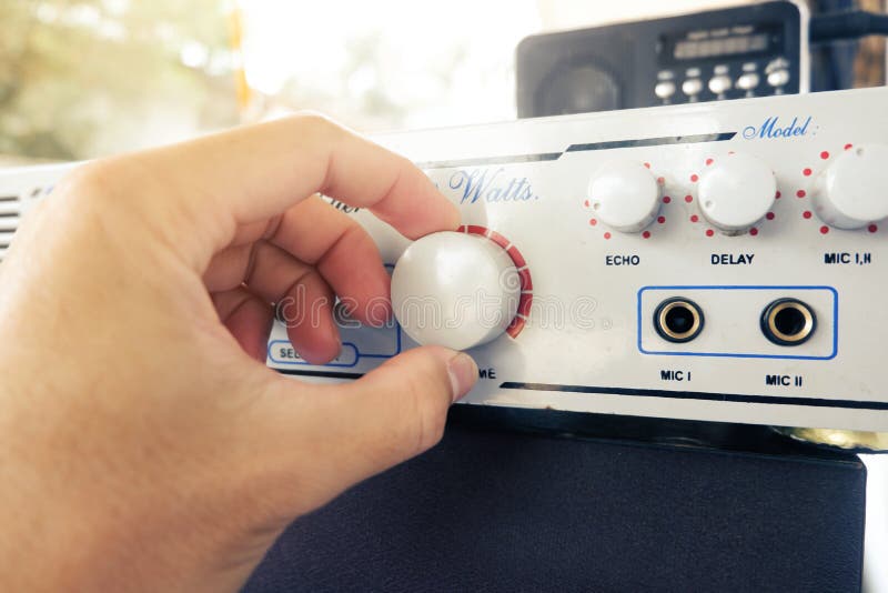 Use Hand To Adjust the Volume at the Volume Control Button of the ...