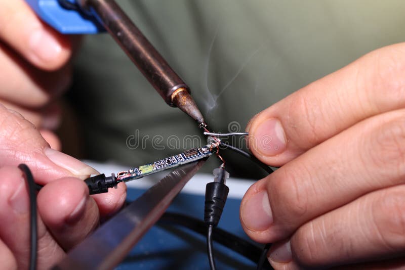 Use Soldering Iron To Weld Connection Pore with Tin Wire. Stock Photo ...