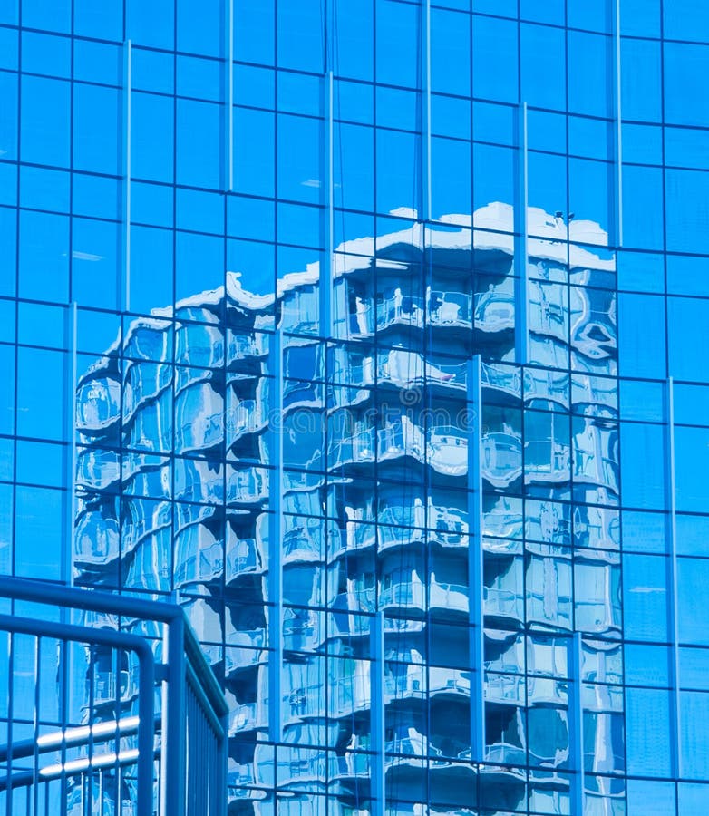 Reflection of a Blue Coloured Highrise in the Windows of Another ...