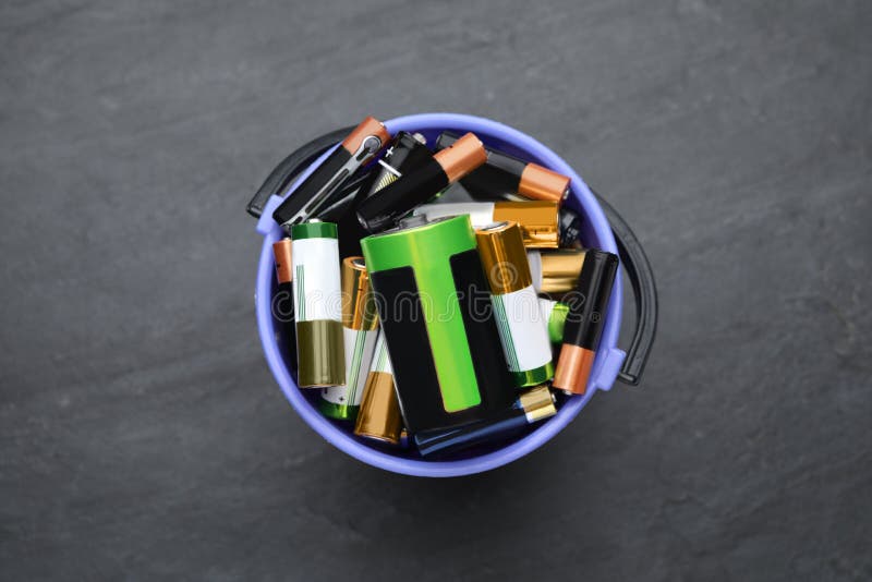 Used Batteries in Bucket on Black Table, Top View Stock Photo - Image ...