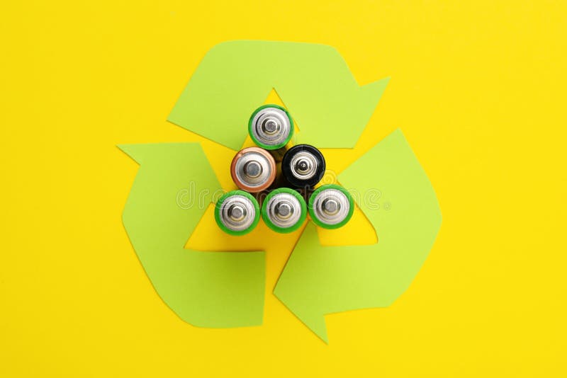 Used Batteries and Recycling Symbol on Yellow Background, Flat Lay ...
