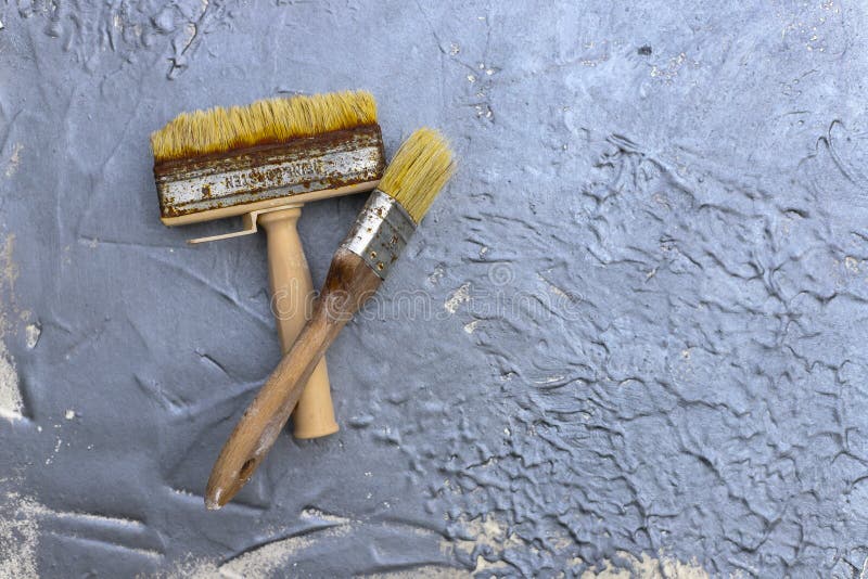 Used Construction Brushes on a Gray Concrete Background Stock Photo ...