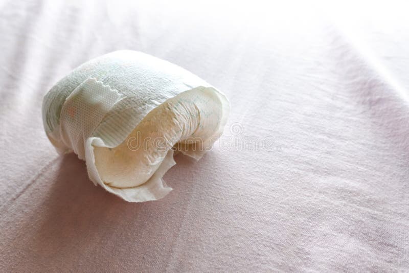 Used Diaper of a Baby on the Bed Stock Photo - Image of excrement ...