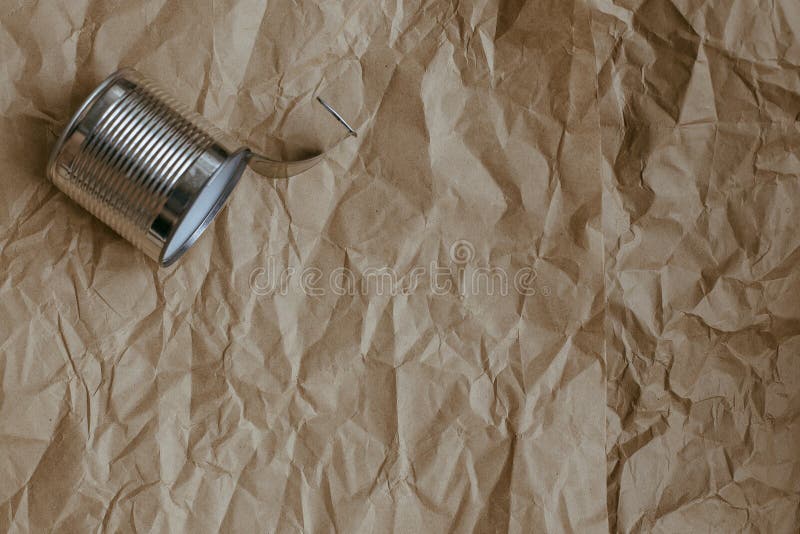 Used Iron Tin Can on a Plain Crumpled Brown Kraft Paper Background ...