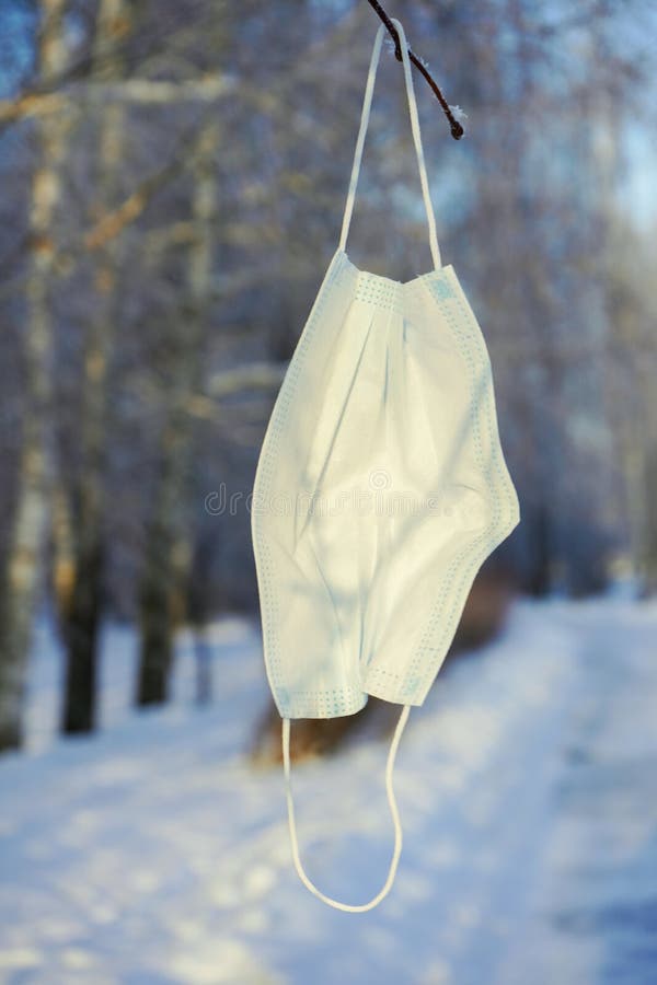 Used Medical Mask Hanging on a Tree Branch, Winter Stock Photo - Image ...