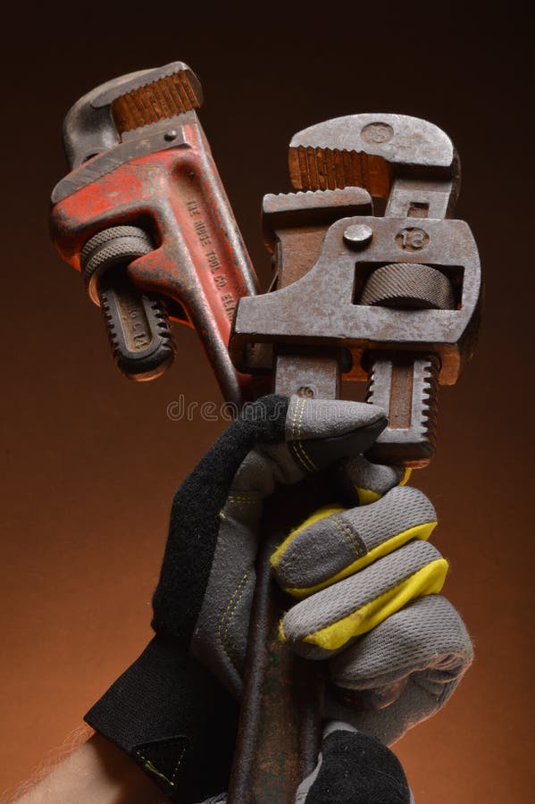 Pipe Wrenches in Hand of Workman Stock Photo - Image of stillson ...