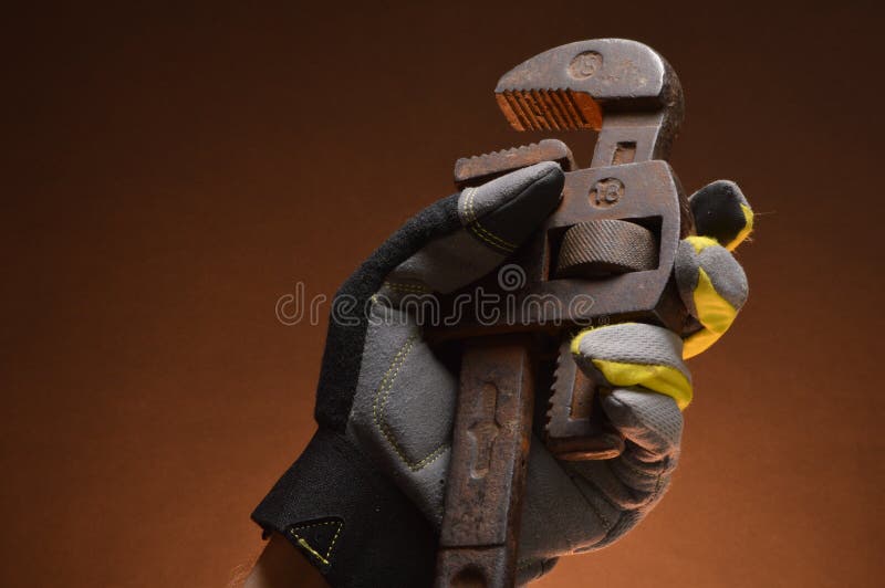Pipe Wrenches in Hand of Workman Stock Photo - Image of glove, strong ...