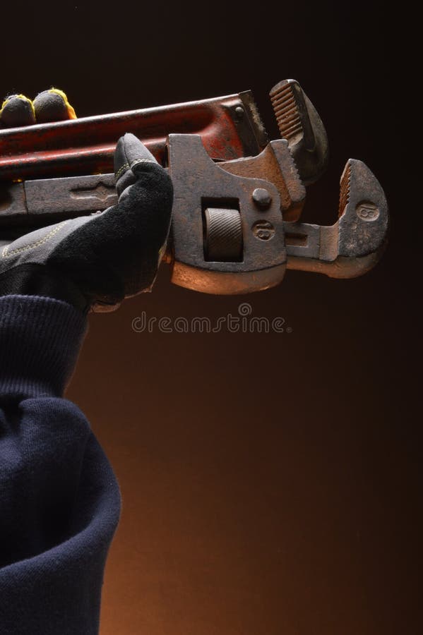 Pipe Wrenches in Hand of Workman Stock Photo - Image of spanner ...