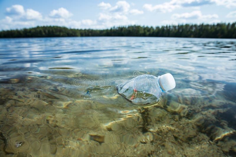 Used Plastic Bottle Floating in Clear Water. Global Environmental ...