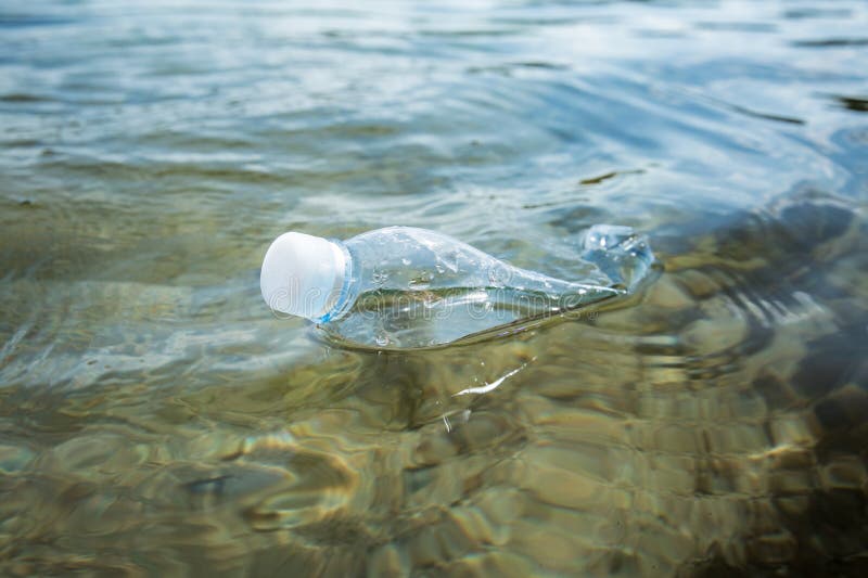 Used Plastic Bottle Floating in Clear Water. Global Environmental ...