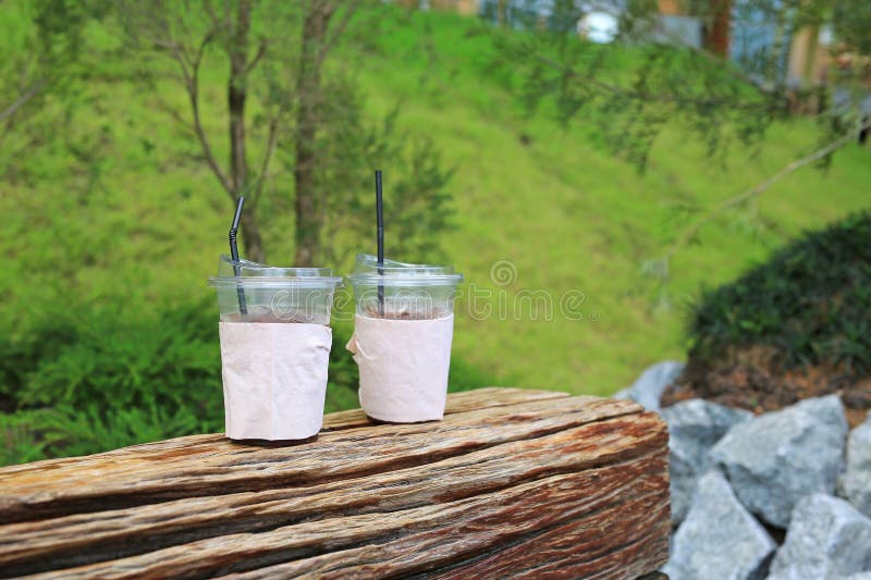 A Used Plastic Drink Cups is Placed on a Wooden Bench in the Garden ...