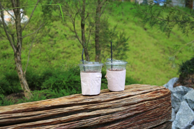 A Used Plastic Drink Cups is Placed on a Wooden Bench in the Garden ...