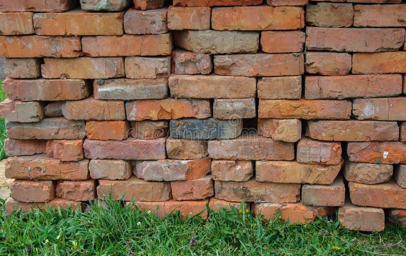Used Red Bricks are Stacked on Green Grass Stock Image - Image of ...