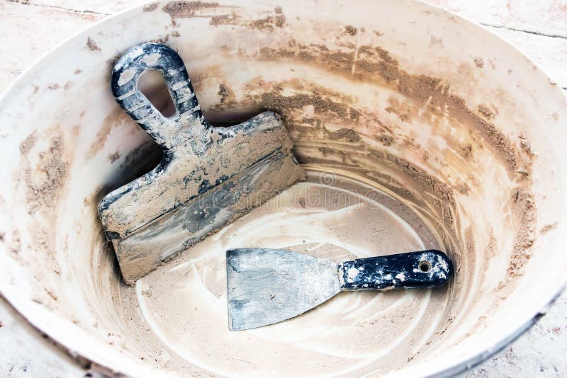 Used spatulas in a bucket stock photo. Image of paint - 83648688