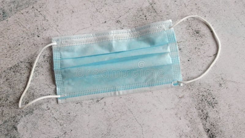Used Surgical Face Mask Isolated on Concrete Floor Stock Video - Video ...