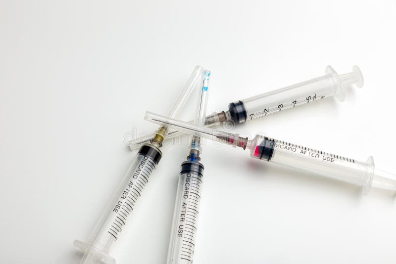 Used Syringes with a Protective Cap on the Needle with Colored ...