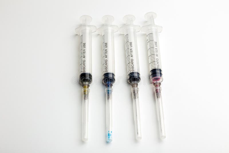 Used Syringes with a Protective Cap on the Needle with Colored ...