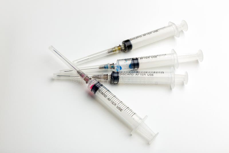 Used Syringes with a Protective Cap on the Needle with Colored ...