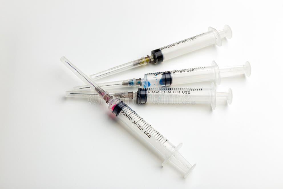 Used Syringes with a Protective Cap on the Needle with Colored ...