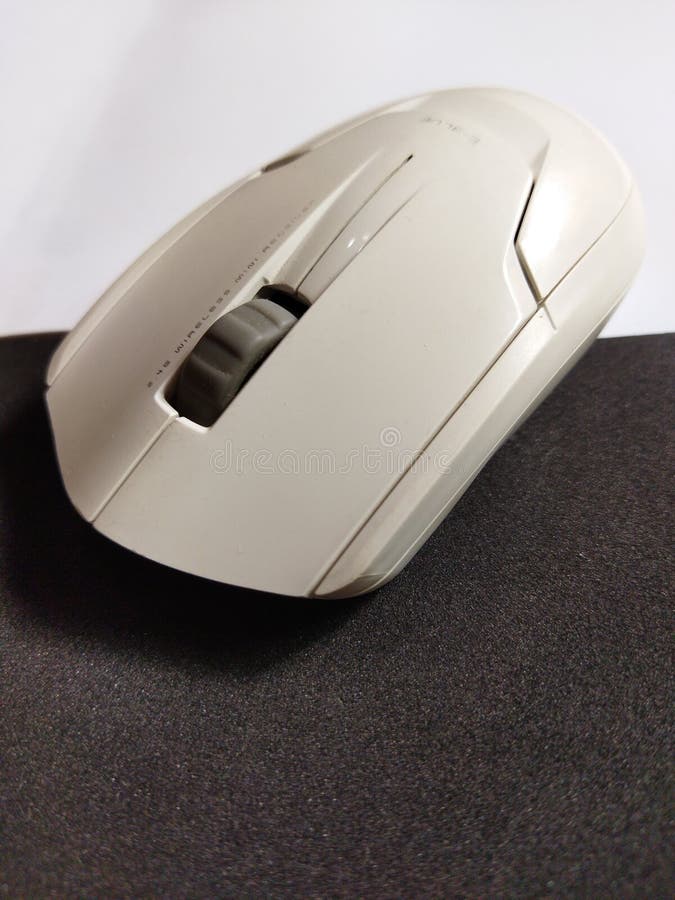 A Used White Wireless or Bluetooth Mouse on a Black and White ...