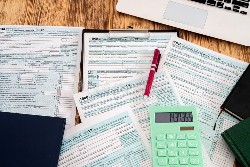 Useful Notebooks with a Red Pen and Tax Forms 1040 Usa Scattered on the ...