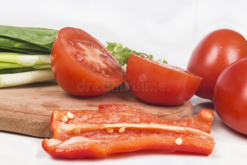 Useful Sliced Tomatoes on a Cutting Board with Red Pepper and Gr Stock ...