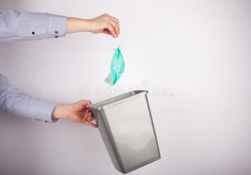 Useless Coronavirus Face Mask - Man Hands Holding Plastic Trash Can and ...