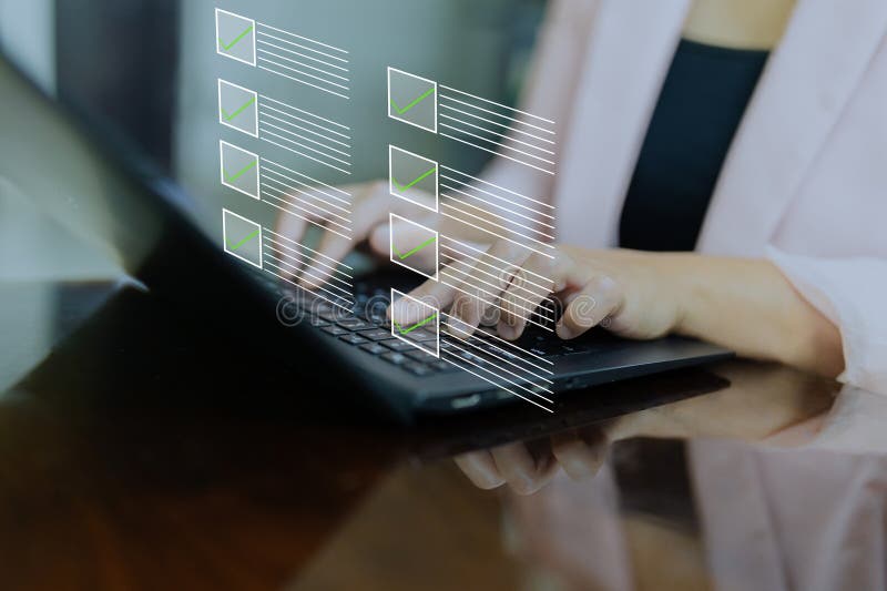 A User is Working on a Laptop with a Digital Checklist Interface ...