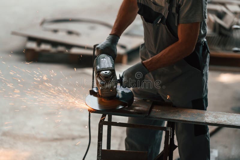 Using Angle Grinder. Close Up View of Man that is Working at the ...