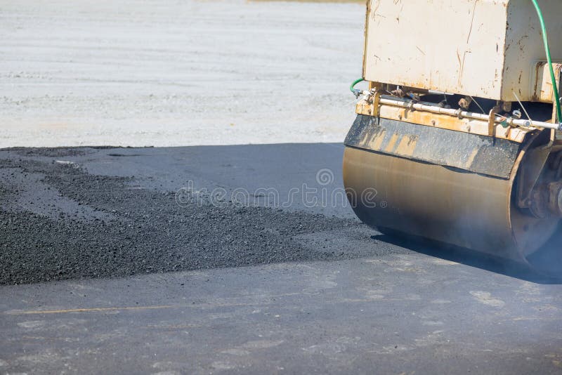 Using an Asphalt Roller, a Worker Lays Asphalt on New Road Stock Image ...