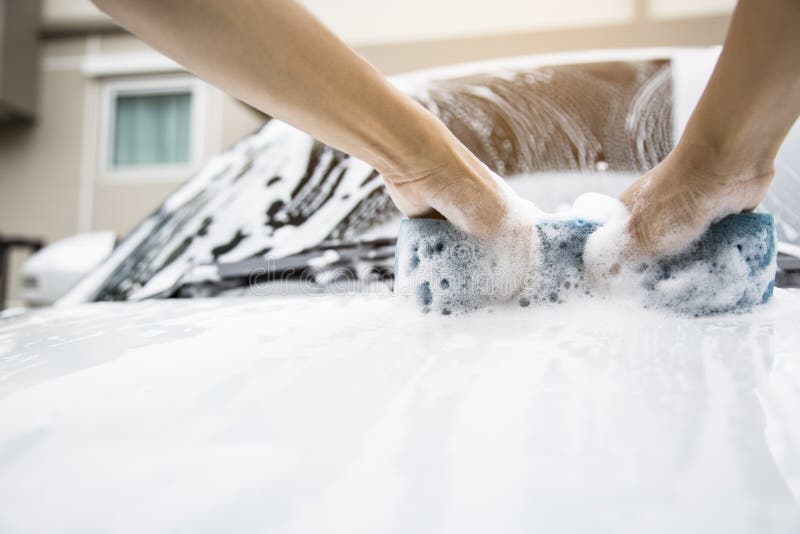 Using Both Hands To Catch the Sponge and Rub on the Bonnet with ...