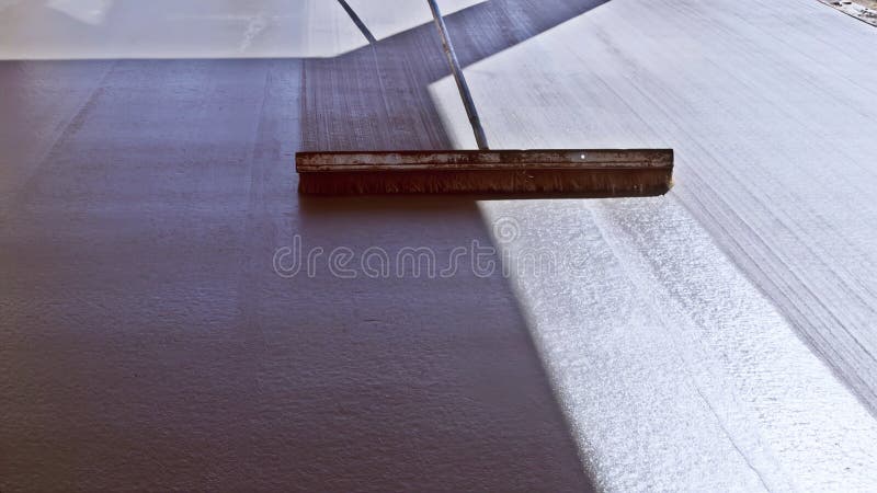 Using a Broom, a Construction Worker Brushes Fresh, Wet Concrete Which ...