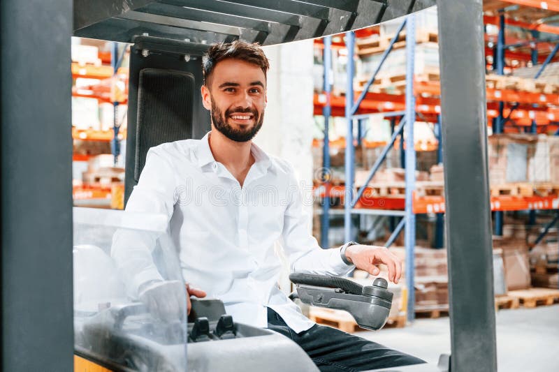 Using Cargo Moving Machine. Storage Worker is in the Warehouse with ...