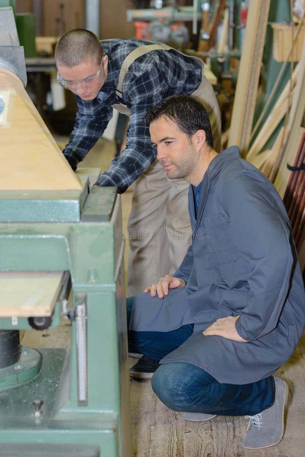 Using a carpentry machine stock image. Image of sticking - 117257489