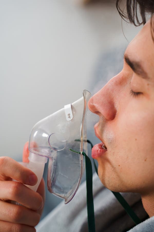 Using Compressor Nebulizer for Disease Treatment at Home. Man Inhaling ...