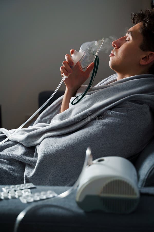 Using Compressor Nebulizer for Disease Treatment at Home. Man Inhaling ...