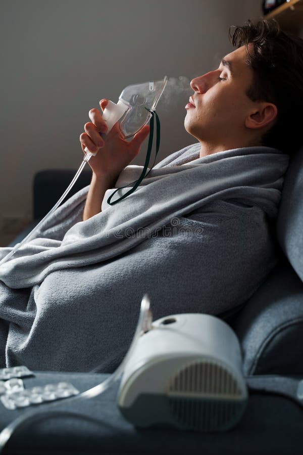 Using Compressor Nebulizer for Disease Treatment at Home. Man Inhaling ...