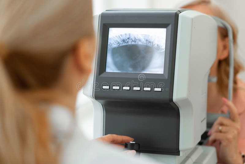 Attentive Professional Therapist Observing Eye Up Close on a Computer ...