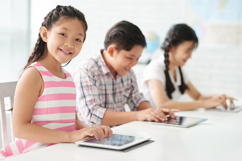 Elementary Students Working at Computers in Classroom Stock Photo ...