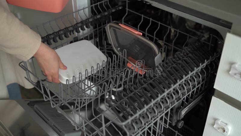 Using Dishwasher Machine. Loading Plastic Pink Reusable Food Container ...