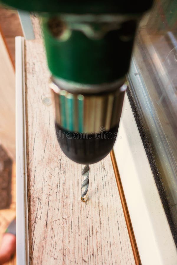 Using a Drill To Drill a Hole in a Board Stock Image - Image of ...