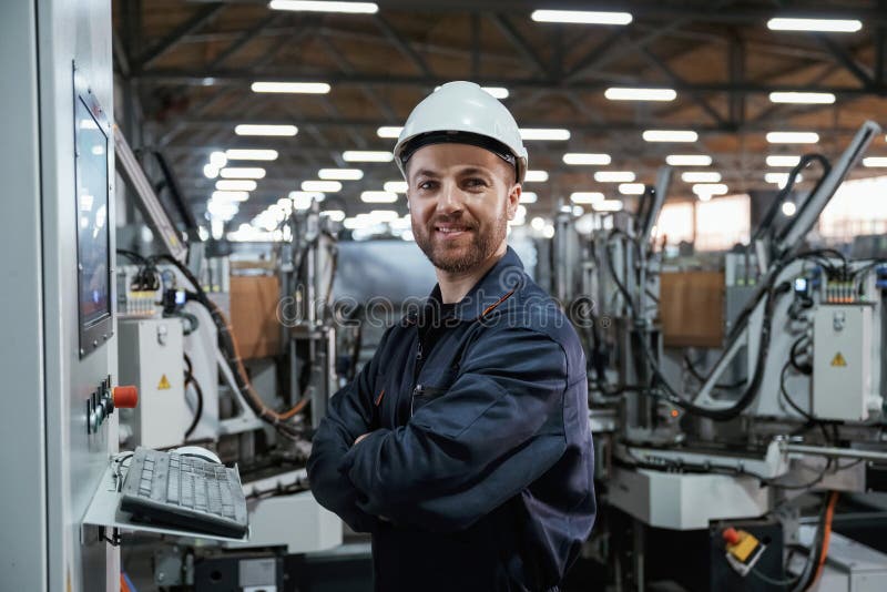 Using Equipment, Operator. Factory Worker is Indoors with Hard Hat ...